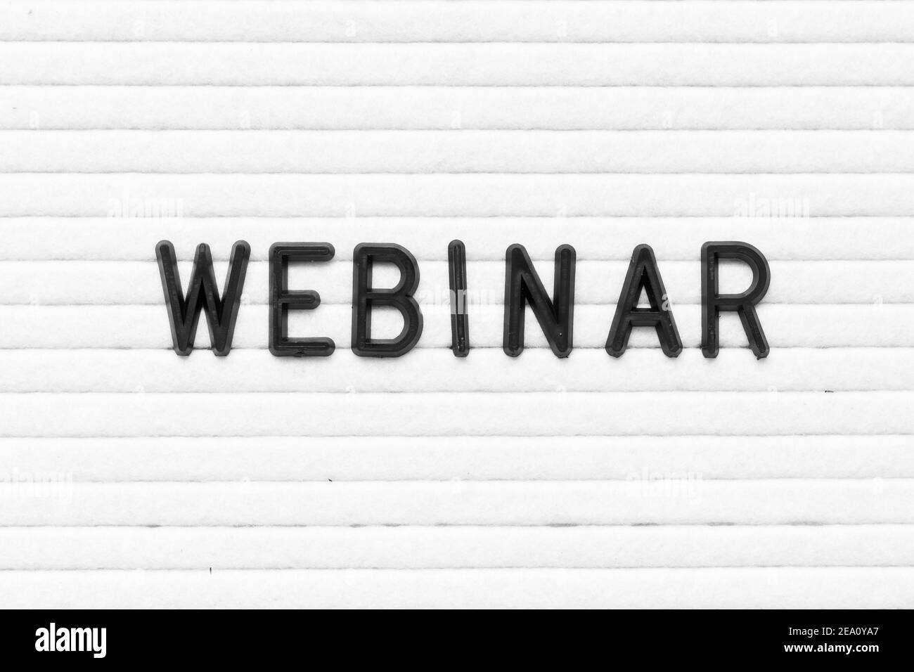 Black color letter in word webinar on white felt board background Stock ...