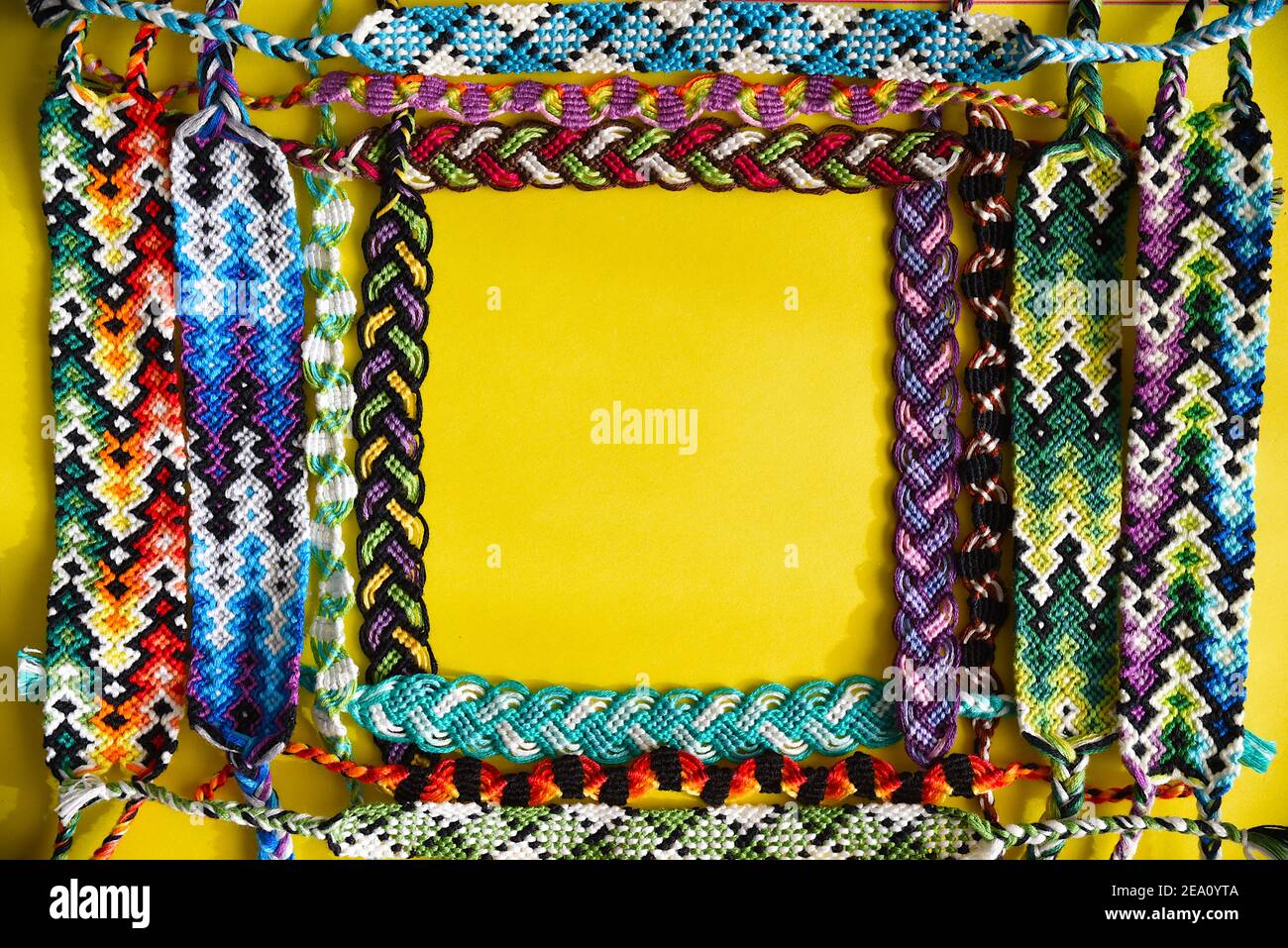 Yellow frame made of woven DIY friendship bracelets Stock Photo - Alamy
