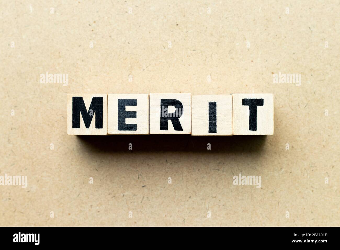 Alphabet letter block in word merit on wood background Stock Photo - Alamy