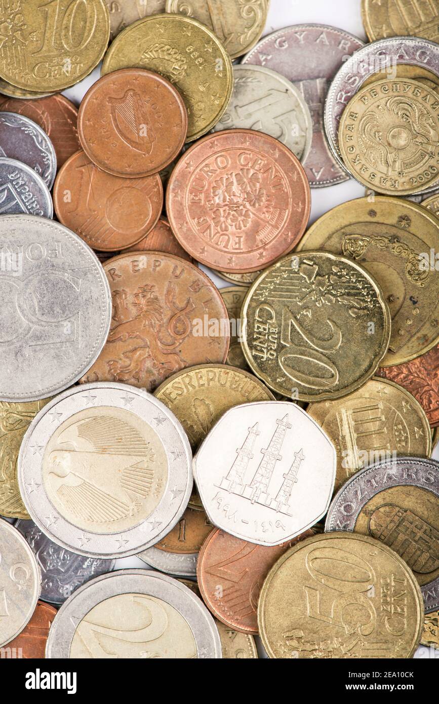 Coins of different countries on a white background Stock Photo - Alamy