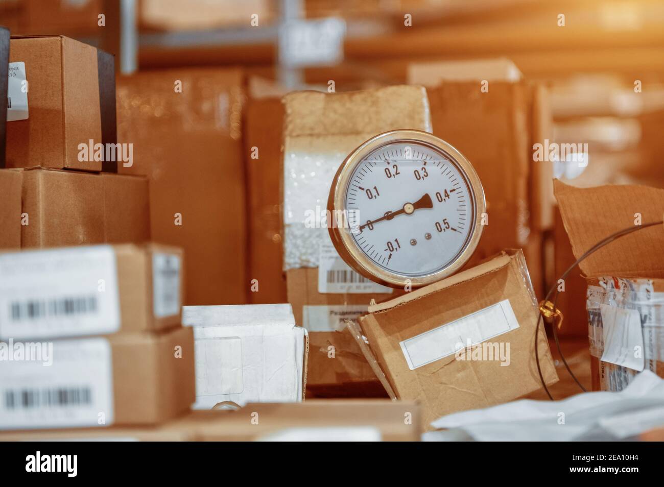 The pressure gauge lies in the middle of the cardboard boxes Stock ...
