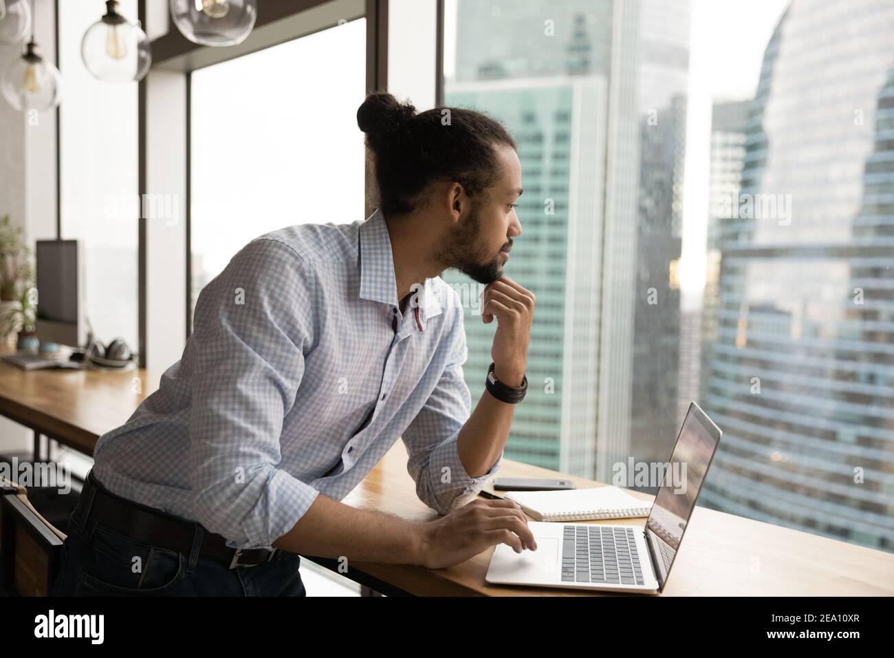 Pensive young black man rest from computer by panoramic window Stock ...