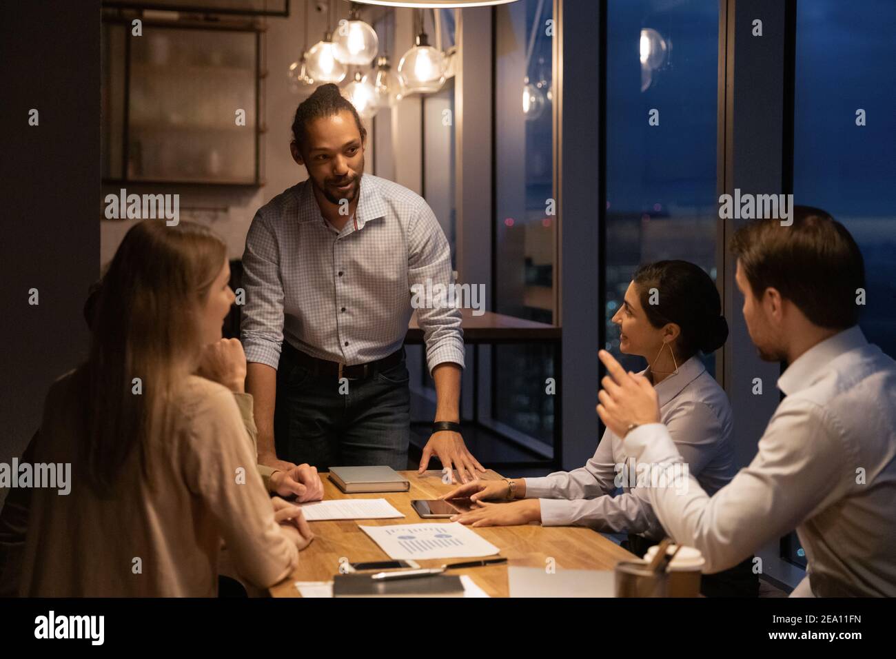 Black male professional coach delivering training to diverse people ...