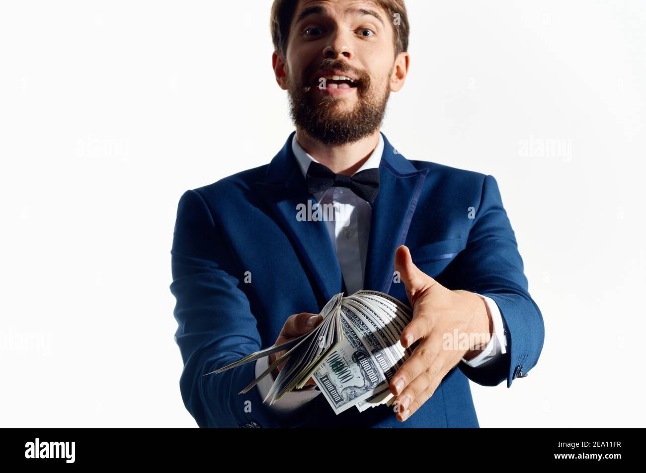 rich man with a bundle of money in his hand and a classic suit on a ...