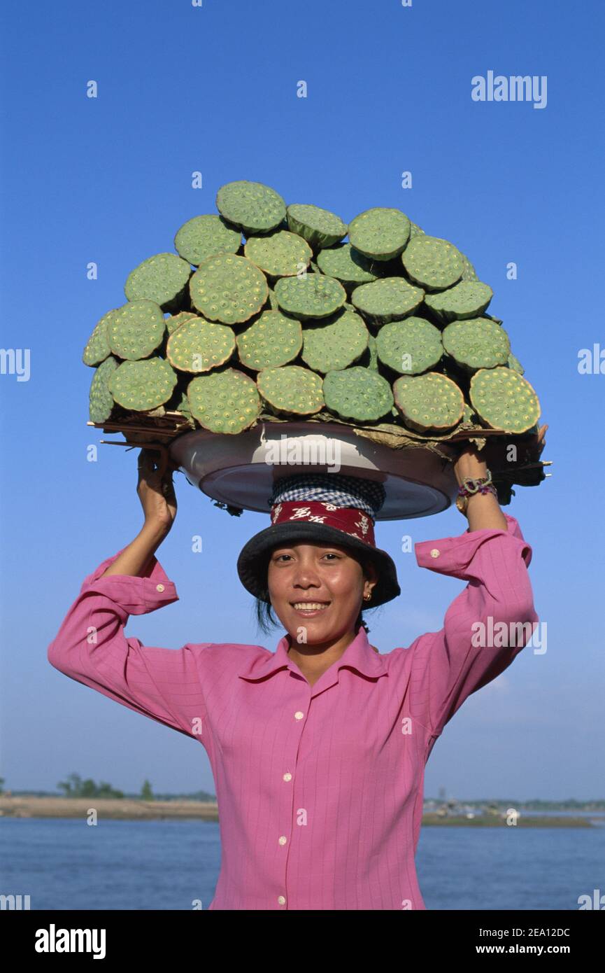 Asia Cambodia, Phnom Penh, portrait of a local Cambodian Woman Carrying ...