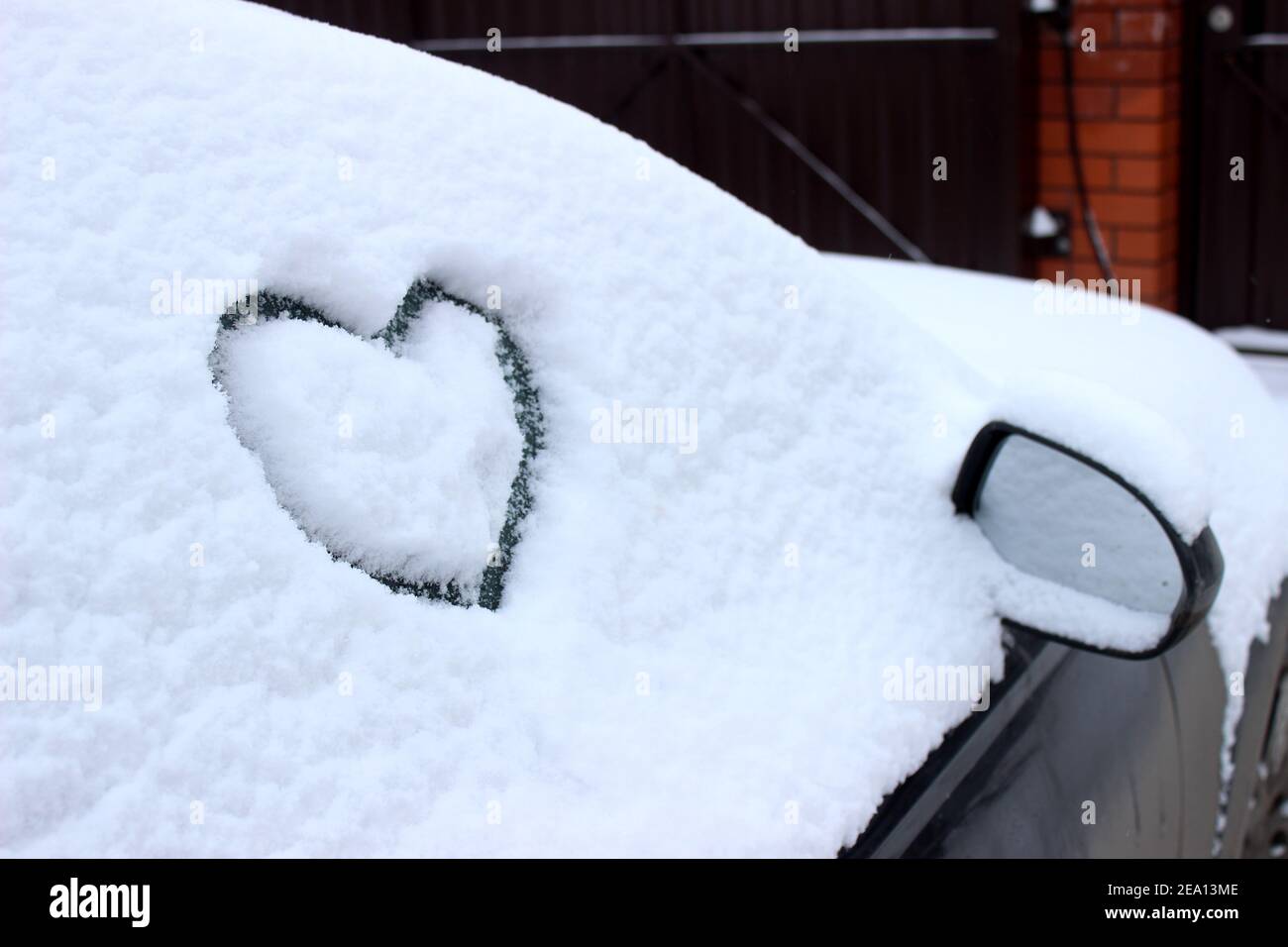 Heart drawn on a car windshield covered with fresh Christmas snow Stock ...