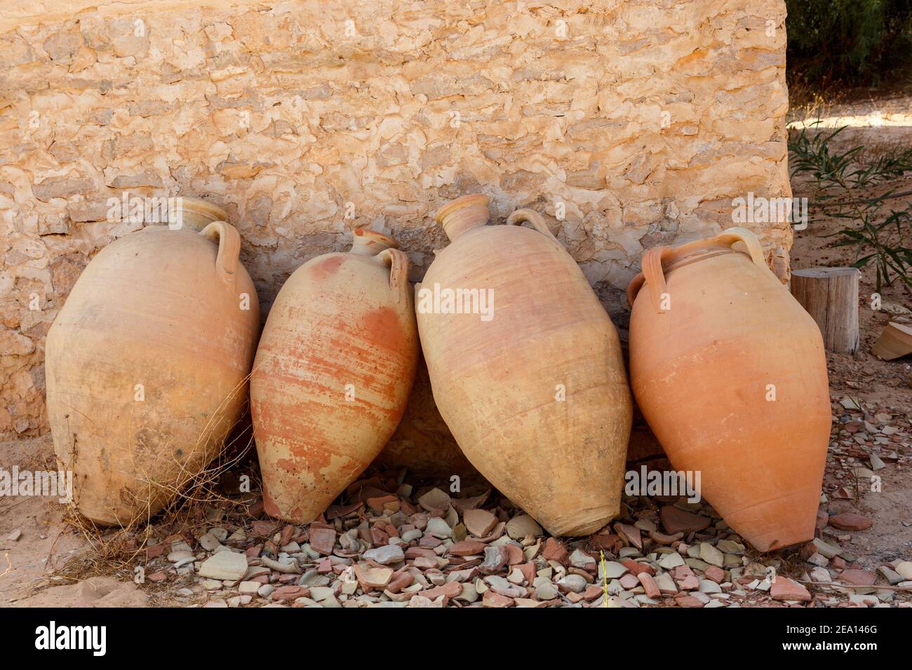 Old earthenware jars against the wall in the shade Stock Photo - Alamy