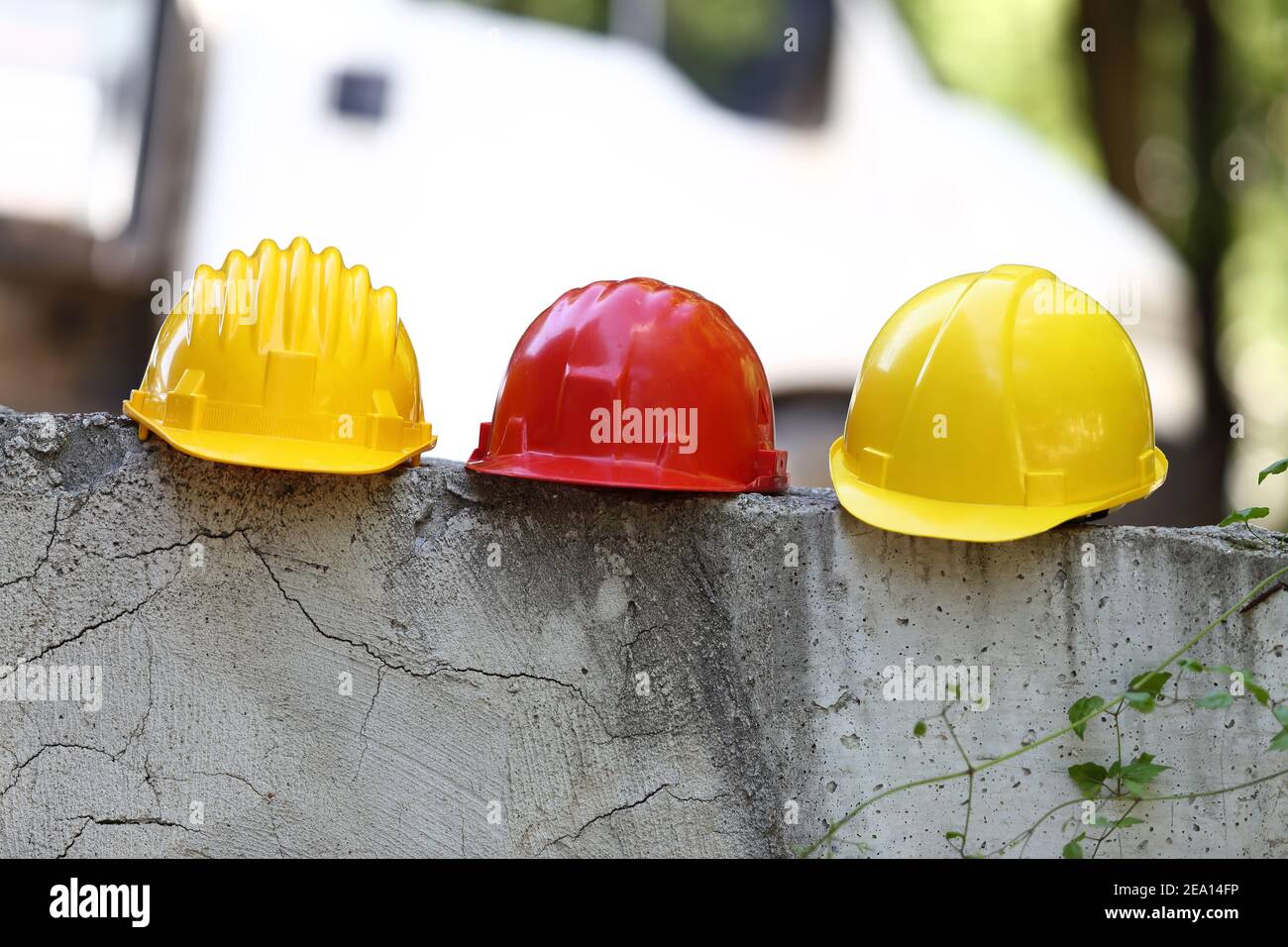 Safety equipment three color helmets Stock Photo - Alamy
