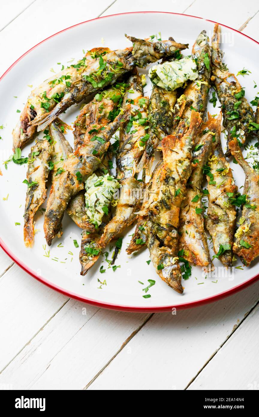 Fried capelin fish with herbs.Fried capelin fish on plate Stock Photo ...
