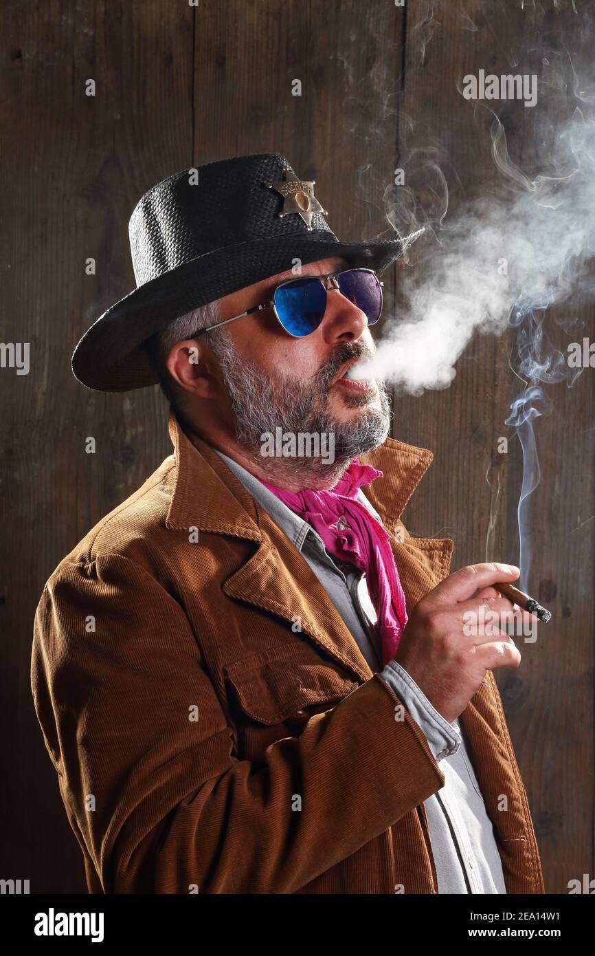 Portrait of a sheriff smoking a cigar Stock Photo - Alamy