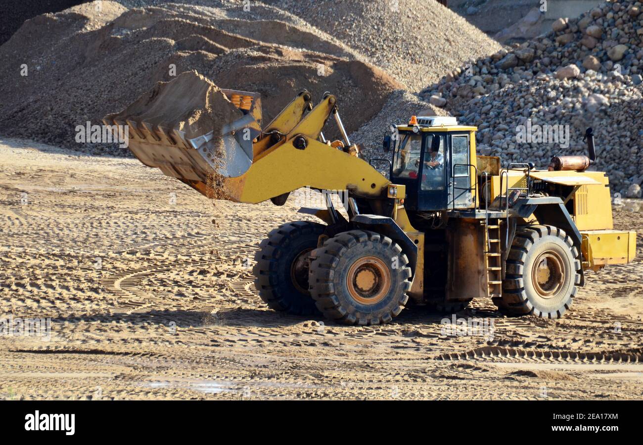 Wheel loader working at the sand open pit. Quarry in which sand and ...