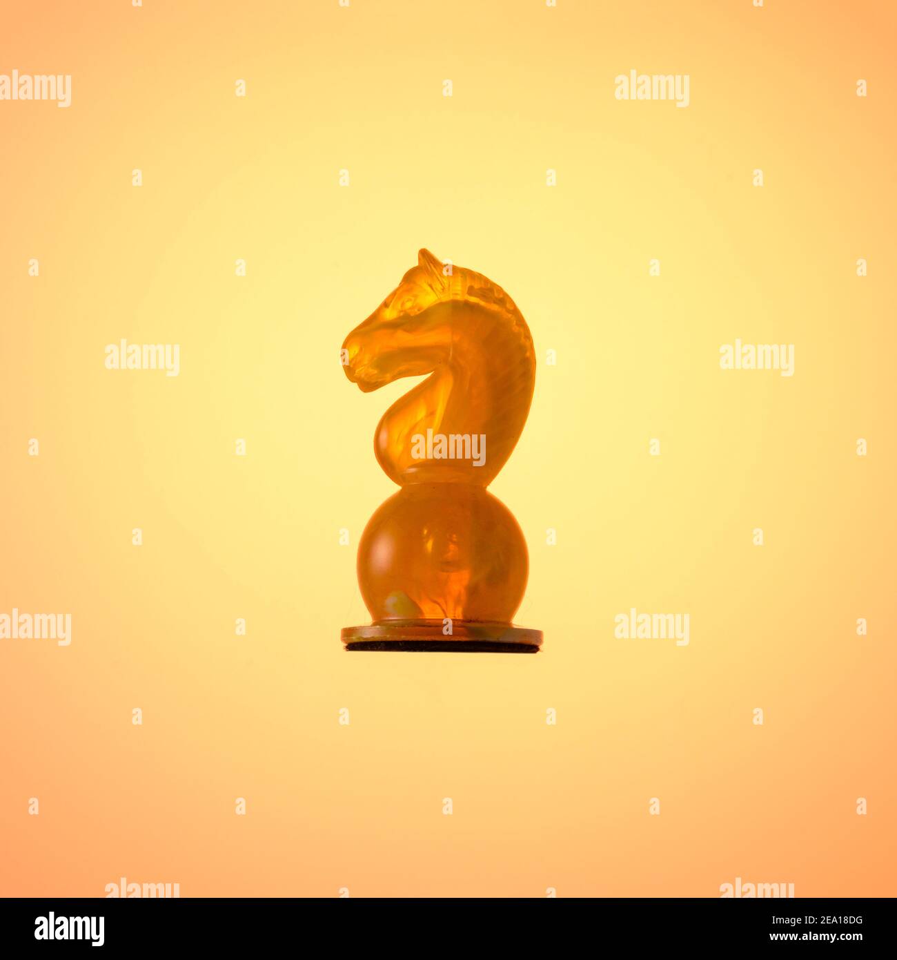 Amber chess set, chess piece White Knight on gold gradient background ...