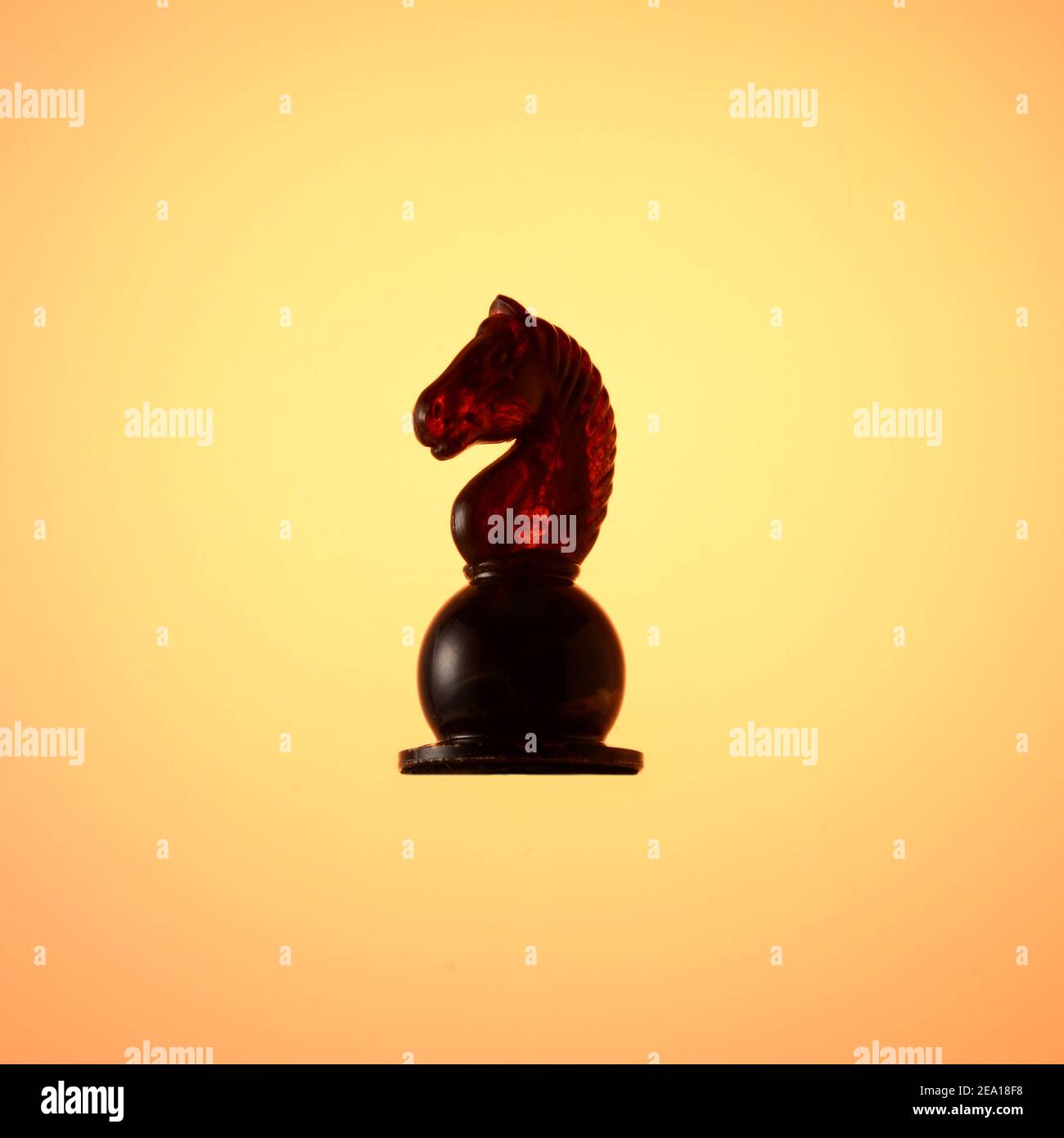Amber chess set, chess piece Black Knight on gold gradient background ...