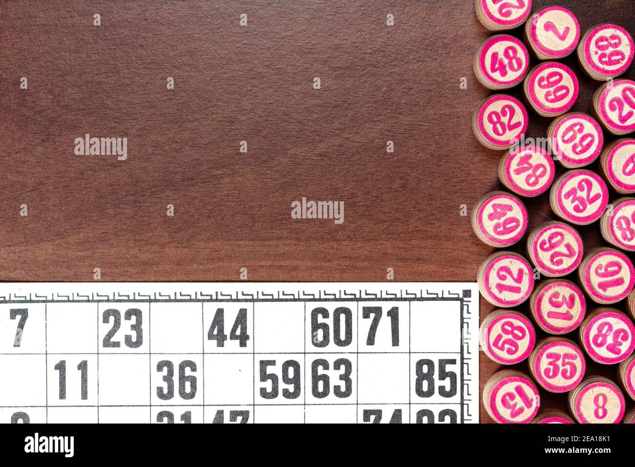 Board game lotto or bingo. Wooden lotto barrels with numbers and card ...