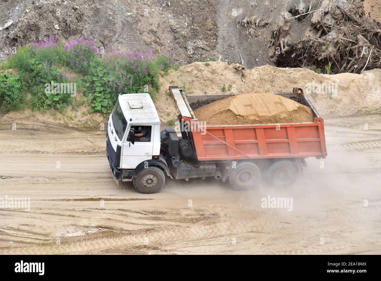 Dump truck transports sand in open pit mine. In the production of ...