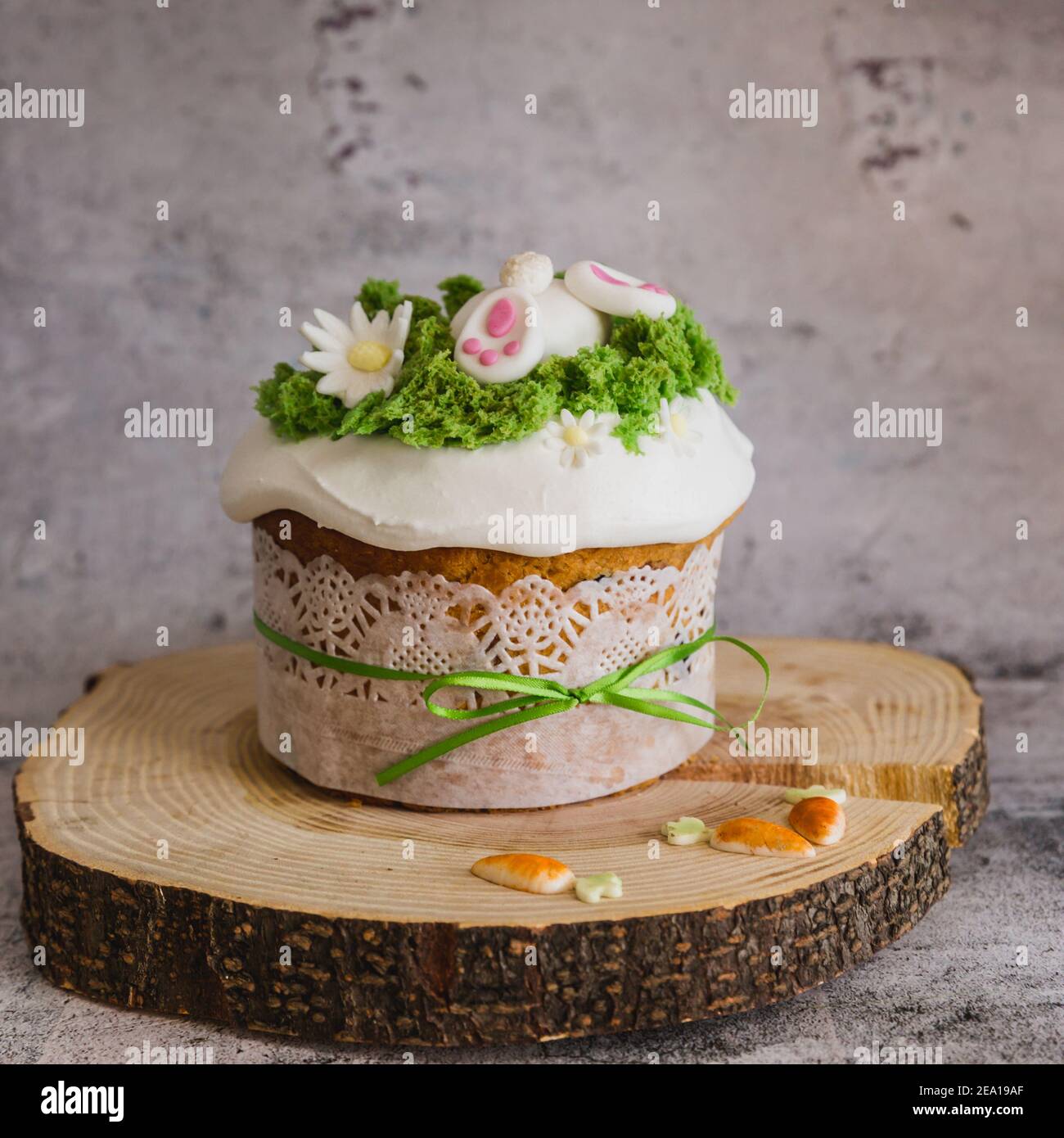 Easter Cakes decorated with a hare dives into a hole on wooden plate ...