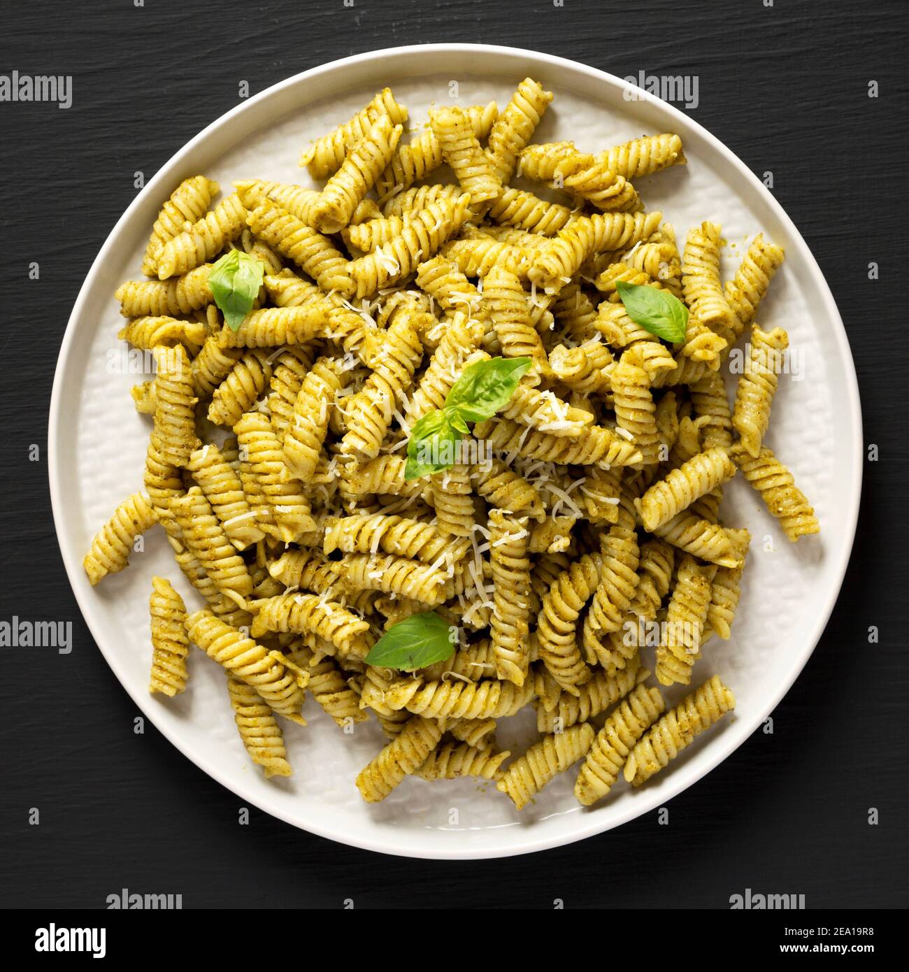 Homemade Pesto Twist Pasta on a plate on a black surface, top view ...