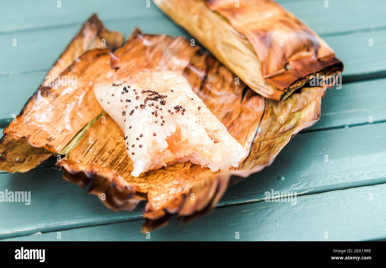 Thai traditional dessert. Grilled Taro Stuffed Coconut Sticky Rice ...