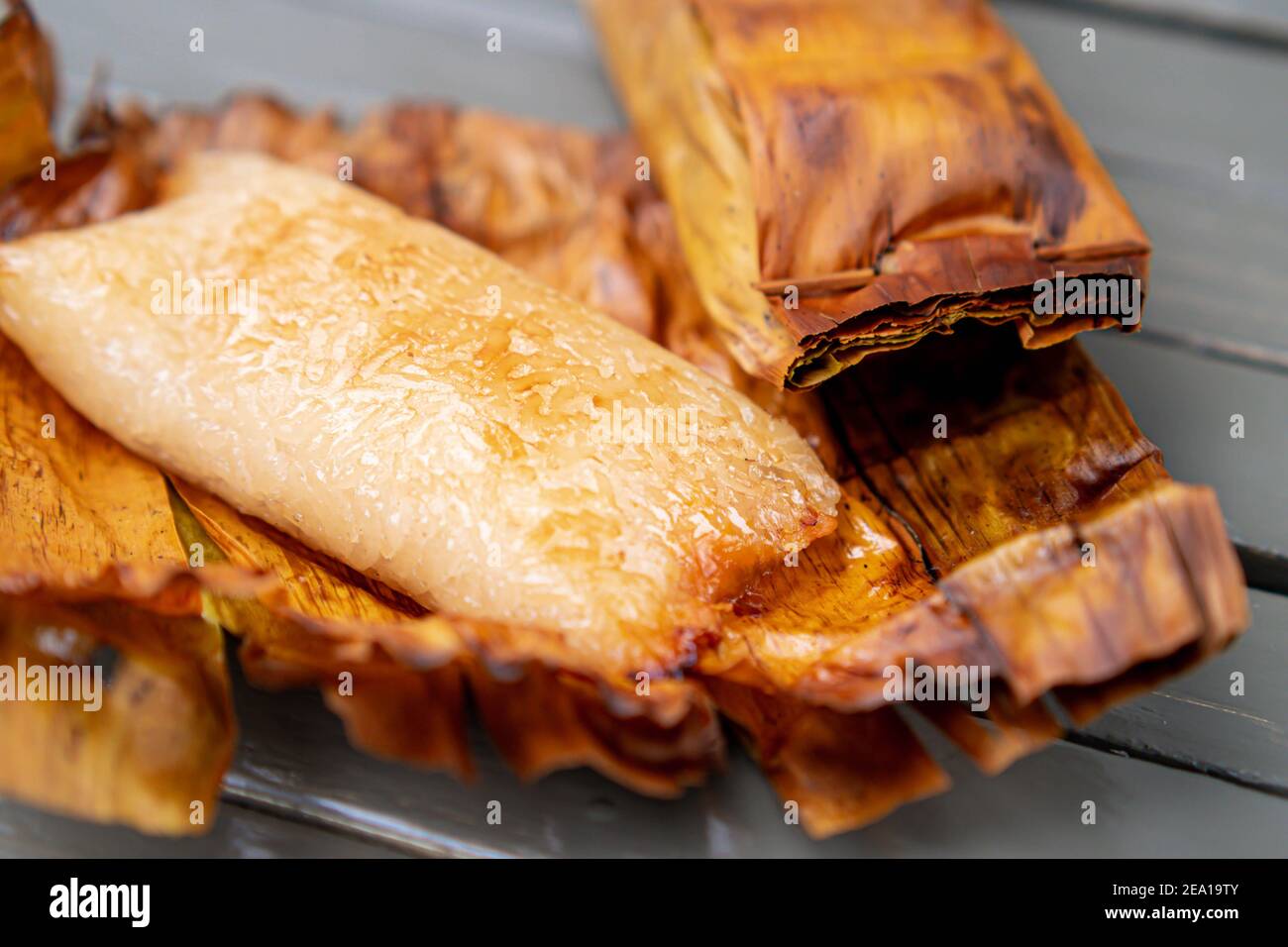 Thai traditional dessert. Grilled Taro Stuffed Coconut Sticky Rice ...