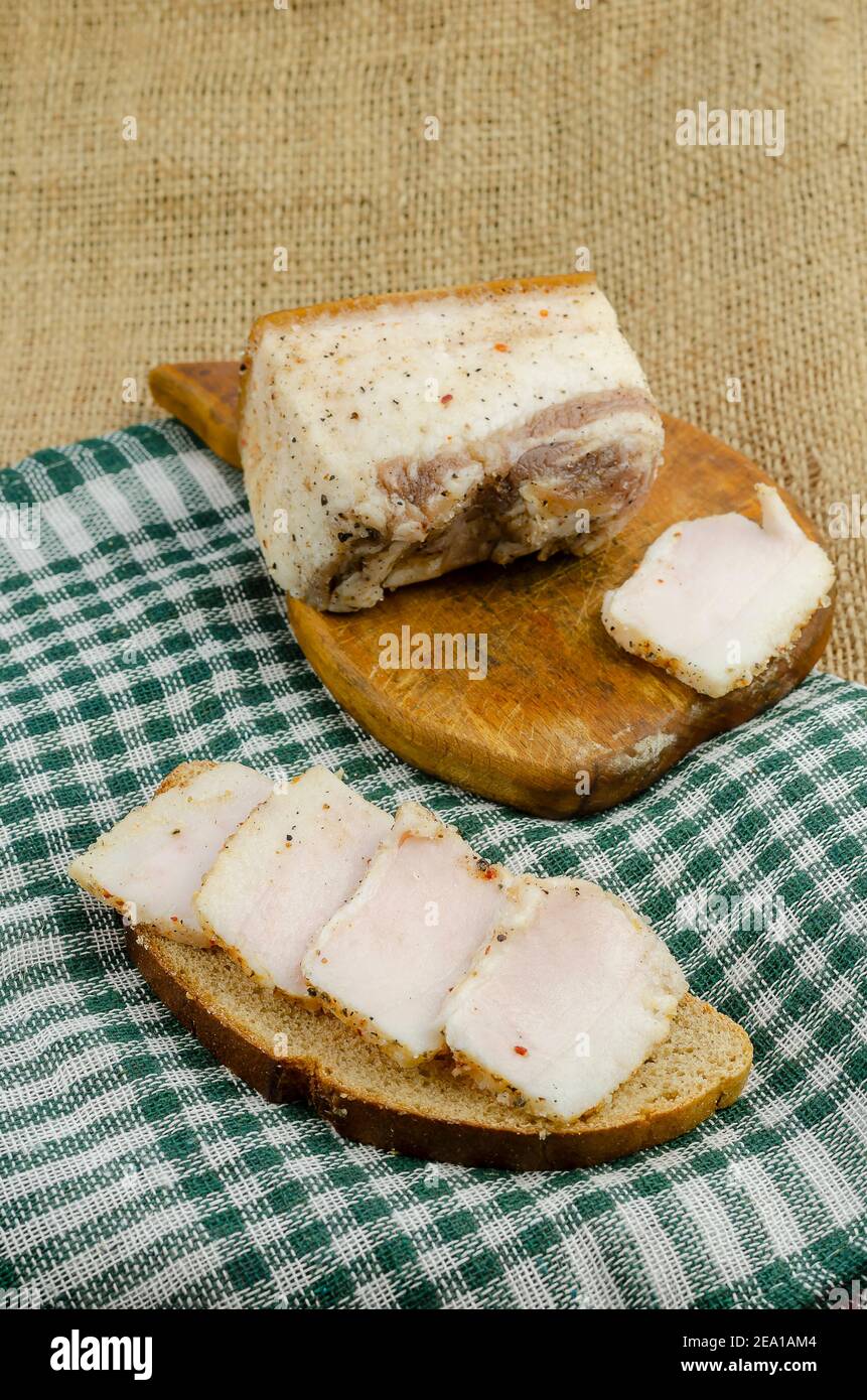 Traditional Ukrainian food. Sliced Salted fat and rye bread on green ...