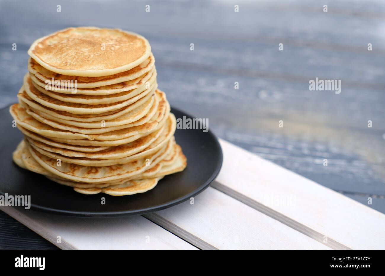 stack of classic american pancakes on a wooden rack. traditional family ...