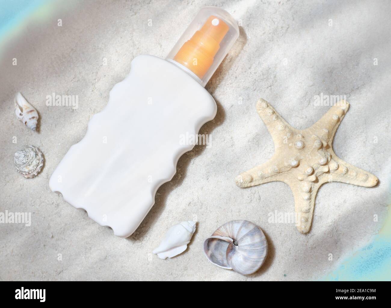 sunscreen lotion under the sea water. starfish and seashells on the ...