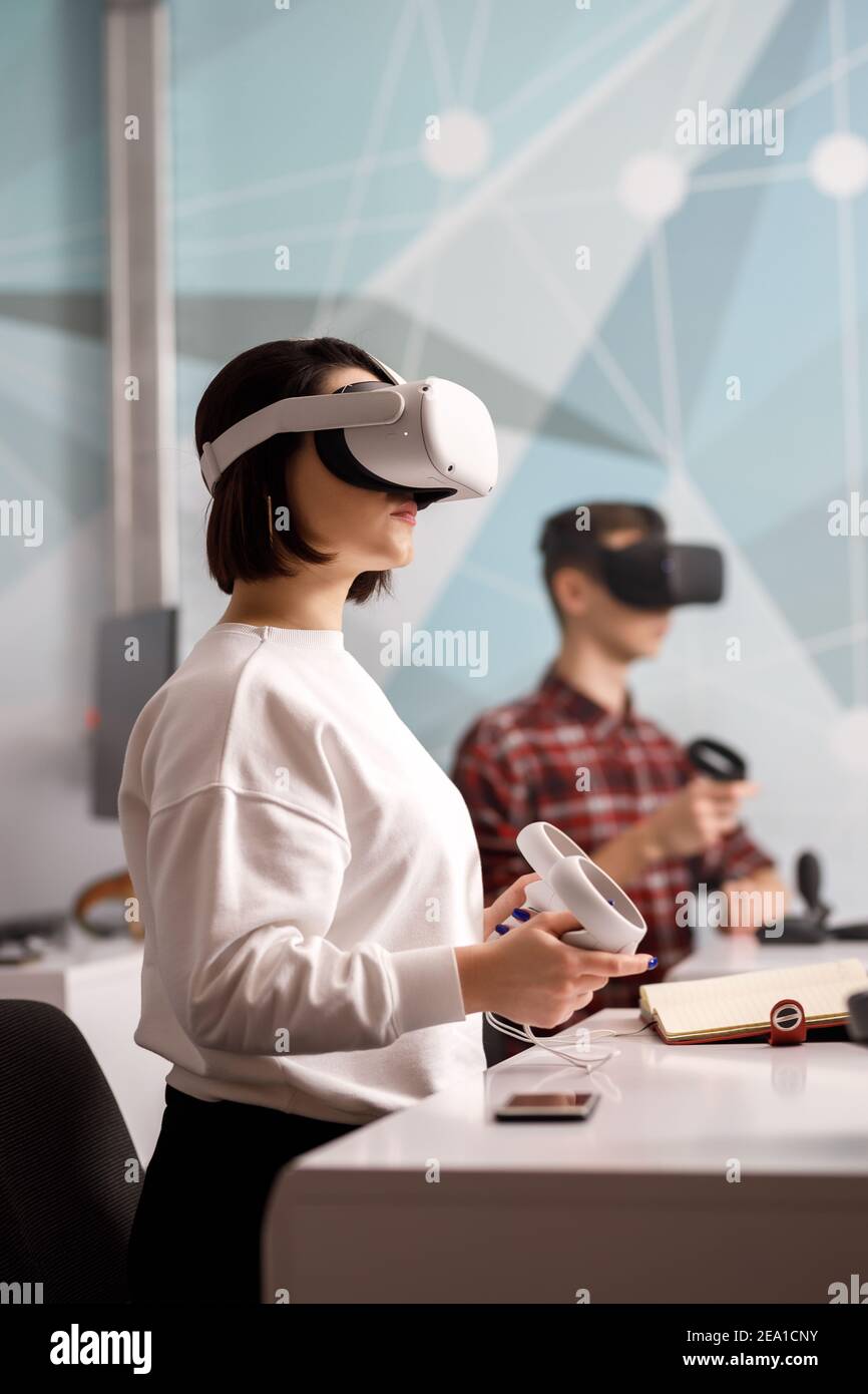team of four creative engineers working with virtual reality, young ...