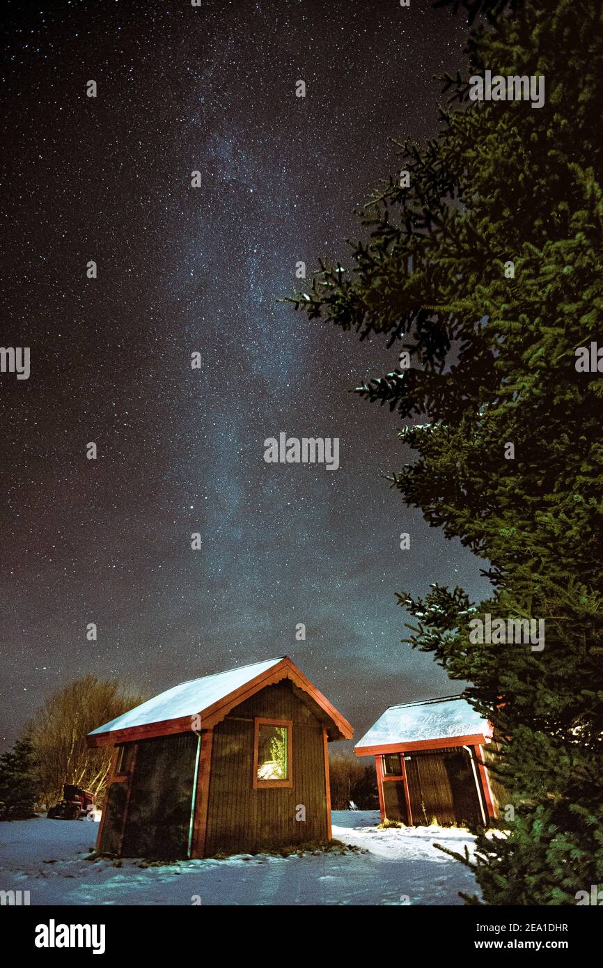 A breathtaking view of small cozy houses under a beautiful starry sky ...