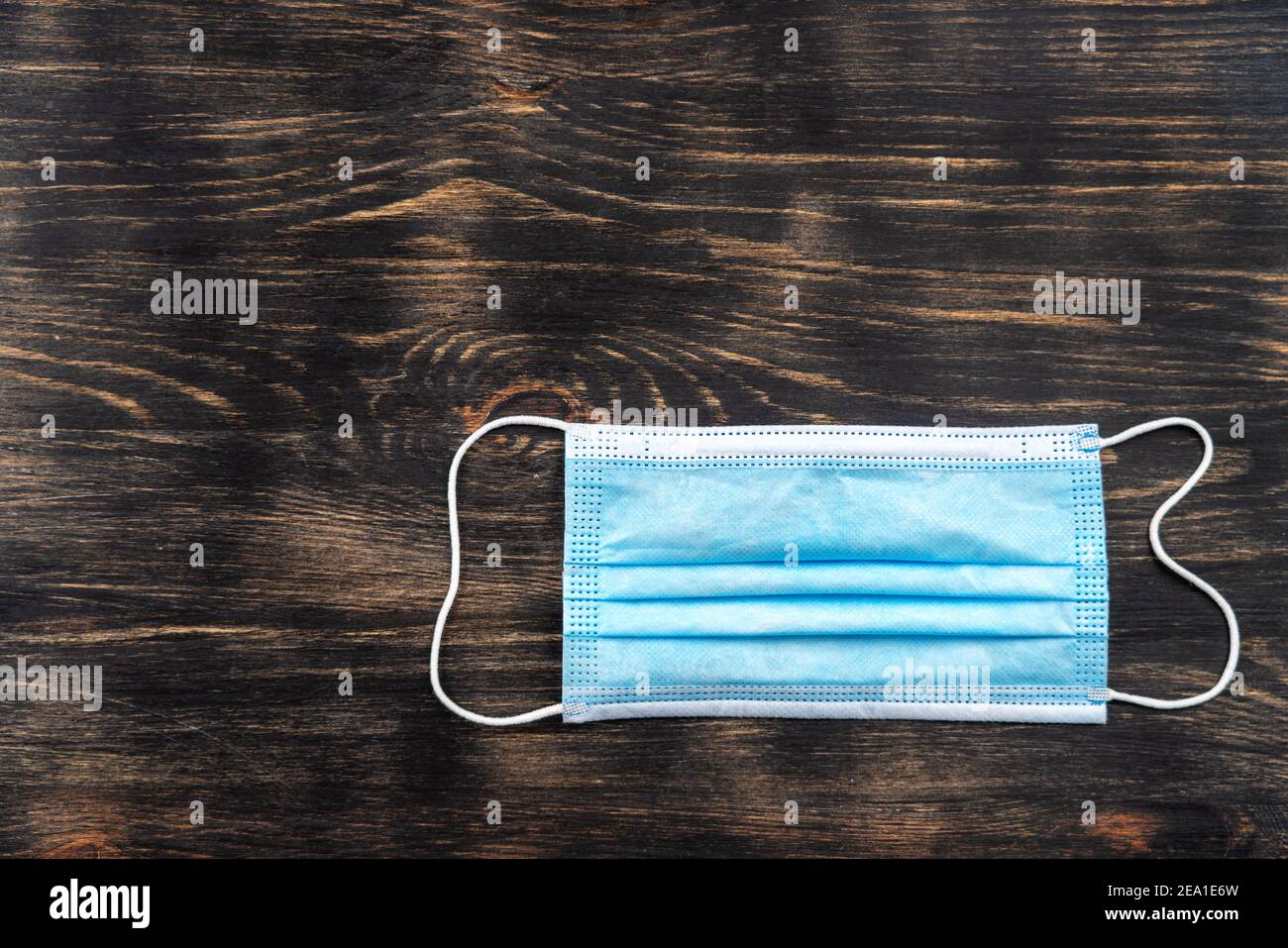 Top view of face mask or surgical mask lays on wooden table with copy ...