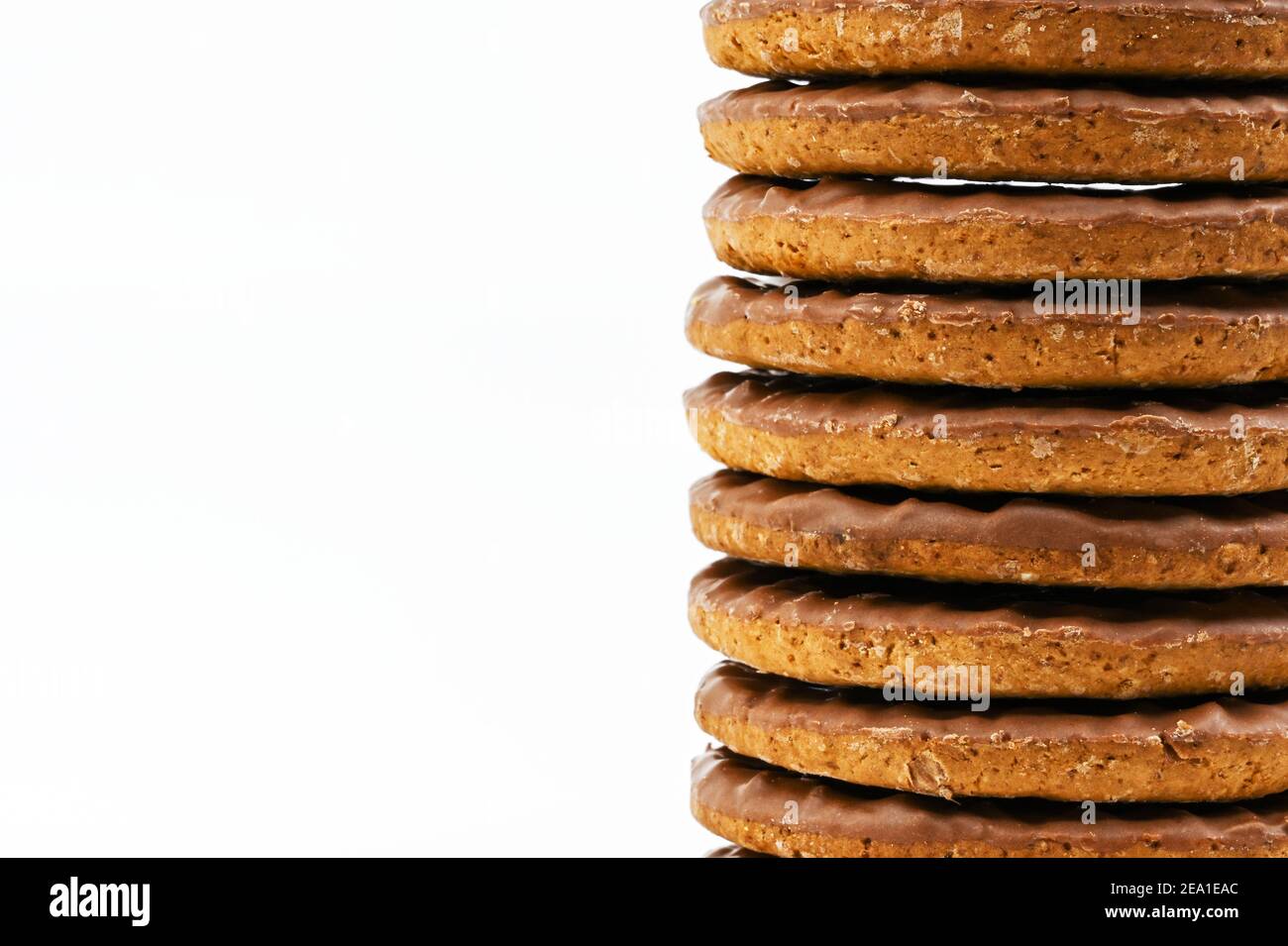 Stack of chocolate covered biscuits against a plain white background ...