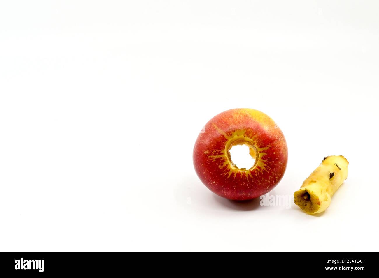 Cored apple with core alongside isolated against a plain white ...