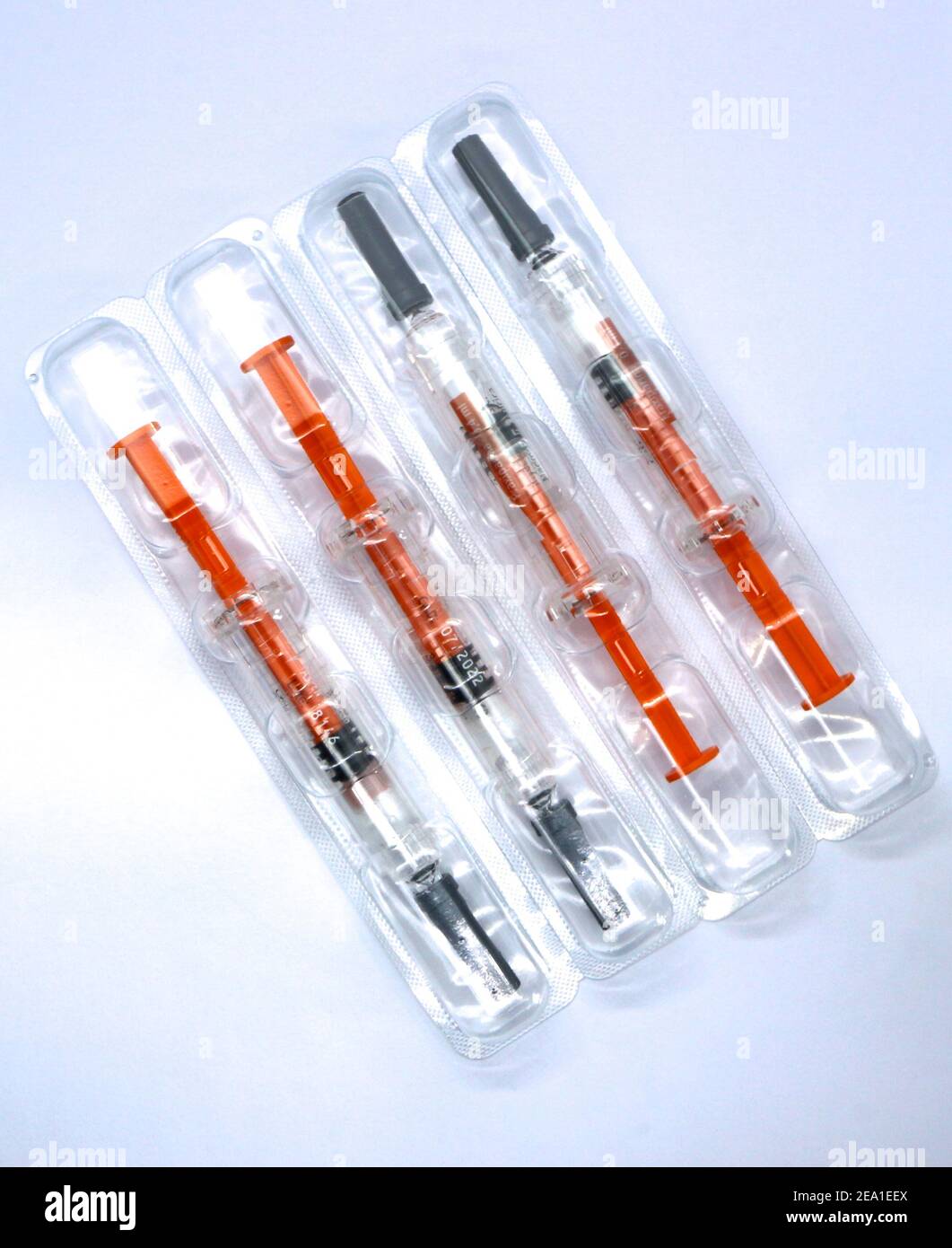 Phot of Transparent black and orange unused sealed plastic syringes pre ...