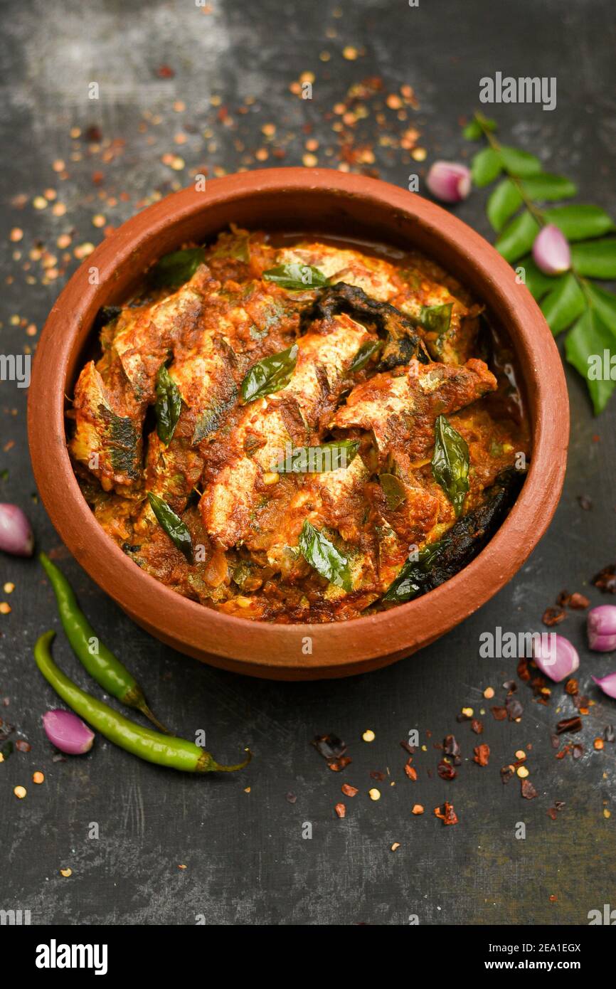 Top view Sardine fish curry spicy Woman hand take Kerala fish curry ...