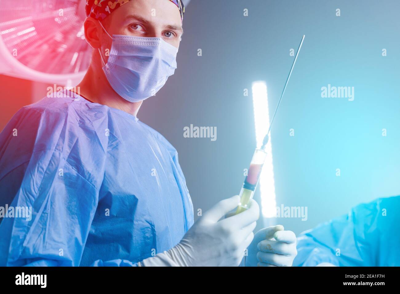 Surgeon holding syringe with humans fat. Liposuction for lipofilling ...