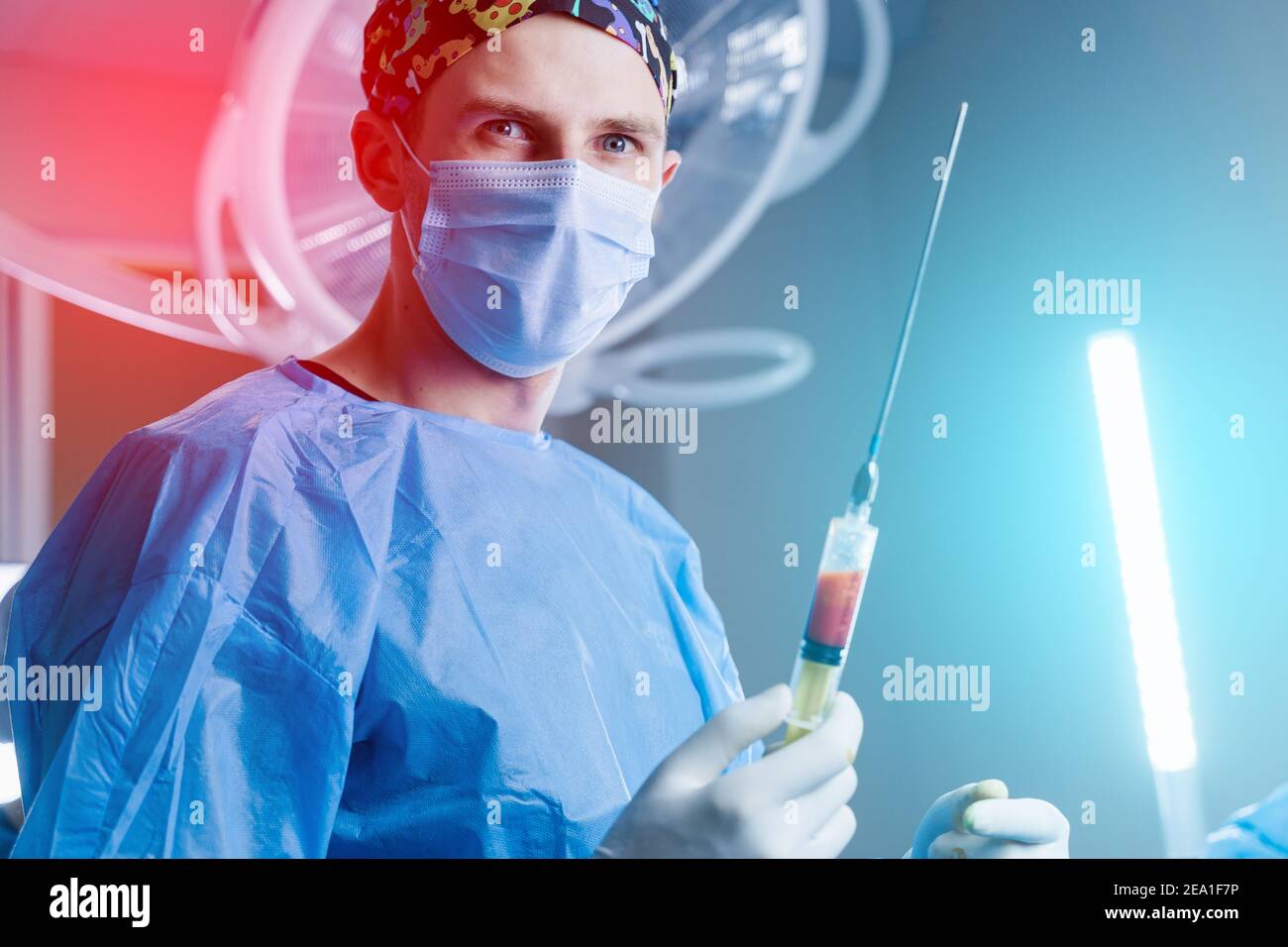 Surgeon holding syringe with humans fat. Liposuction for lipofilling ...