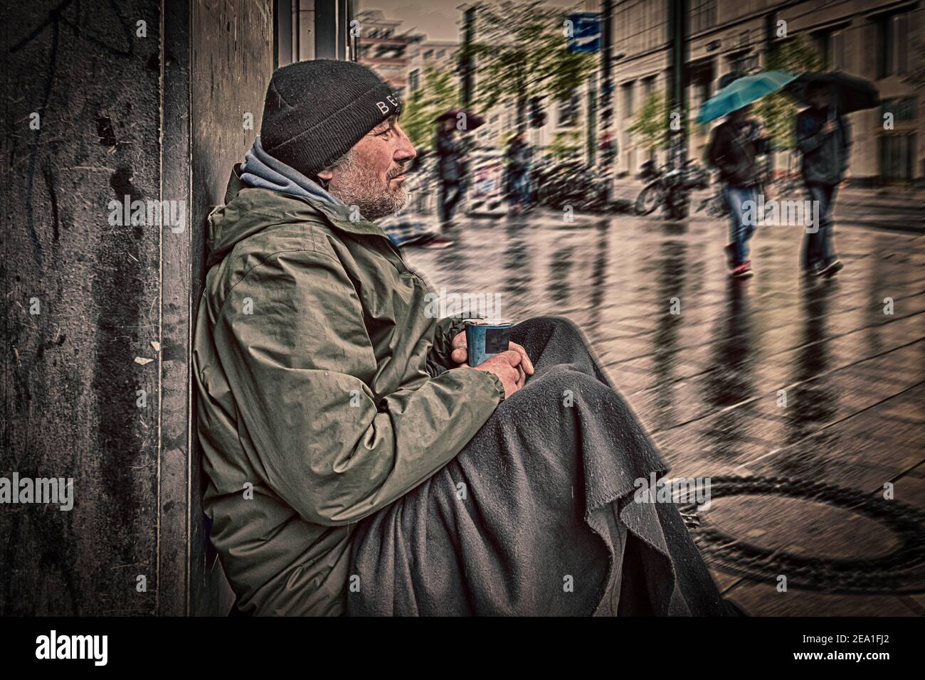 Homeless man sits in rain hi-res stock photography and images - Alamy