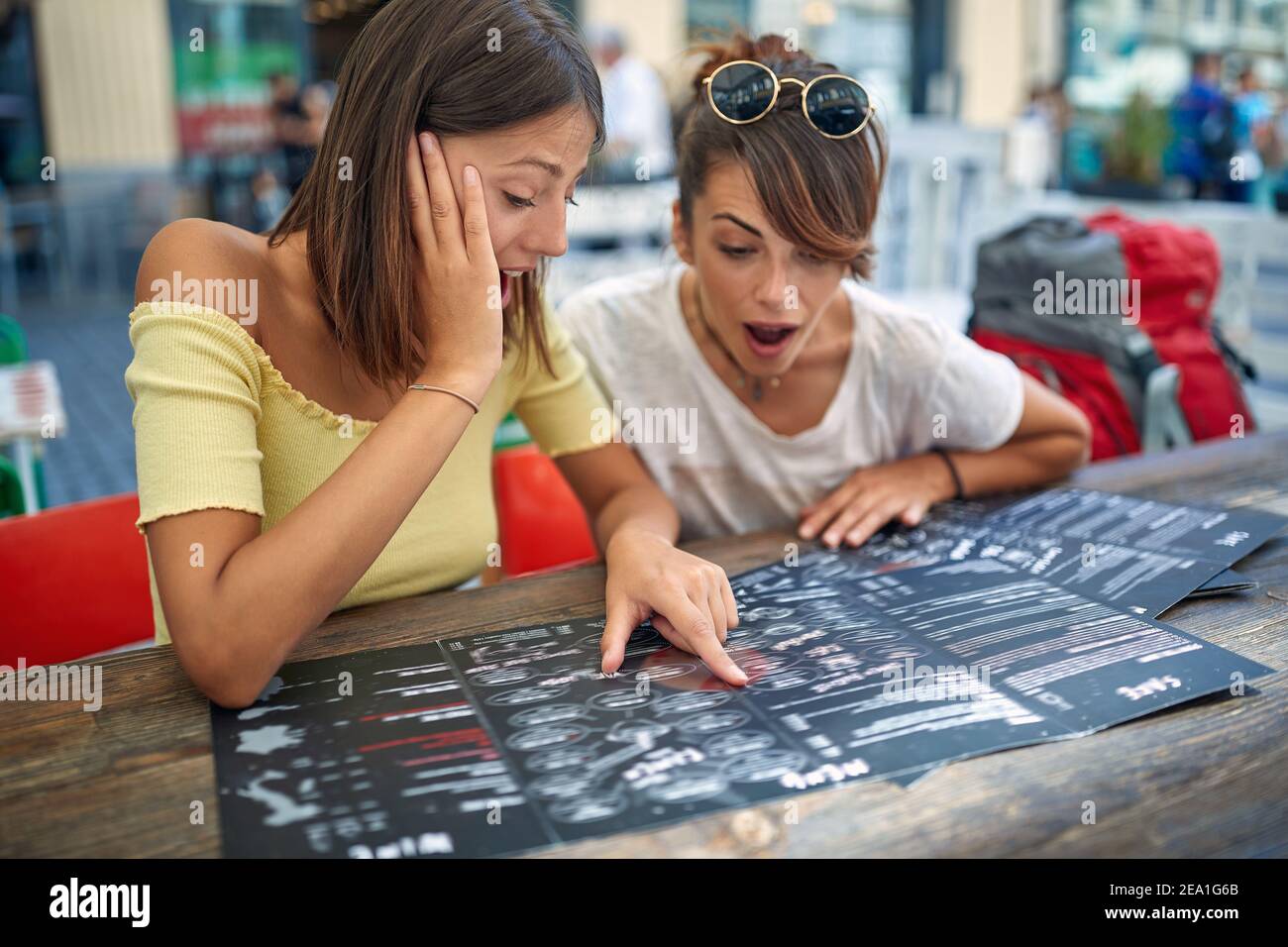 Two friends ordering in a cafe together from menu Stock Photo - Alamy
