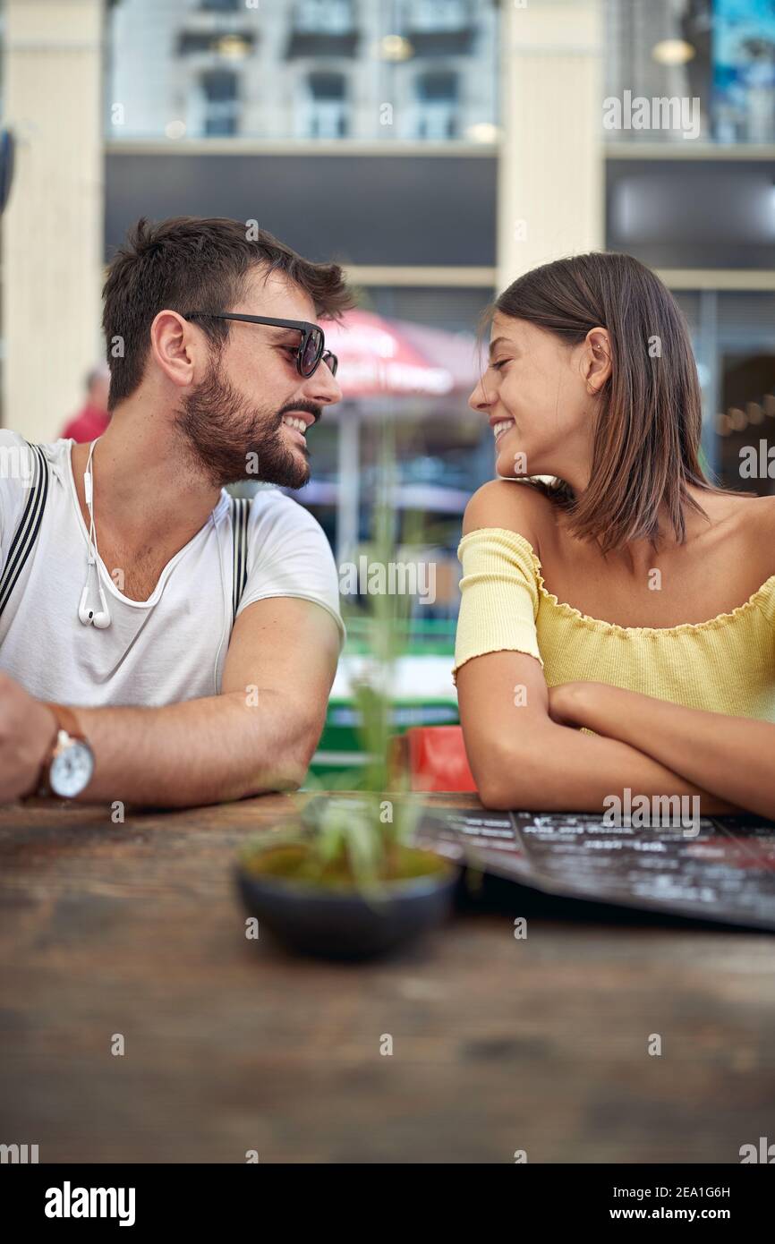 Couple reading the menu together on a date Stock Photo - Alamy