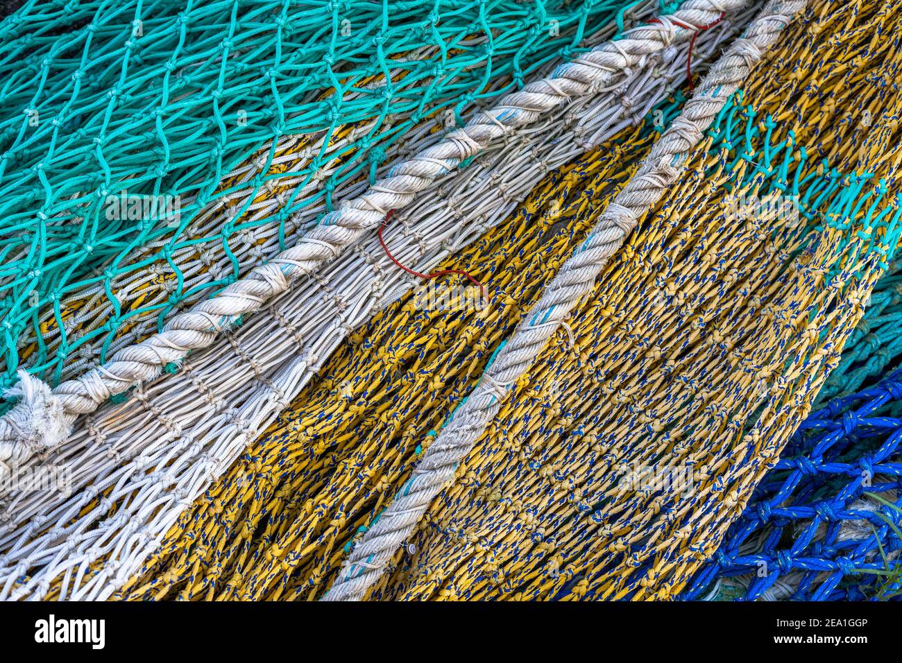 Background with close up of fishing nets, blue, green, yellow, white ...