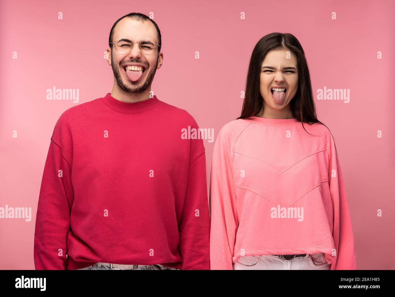 Photo of attractive man wih beard in red clothing and woman in pink ...