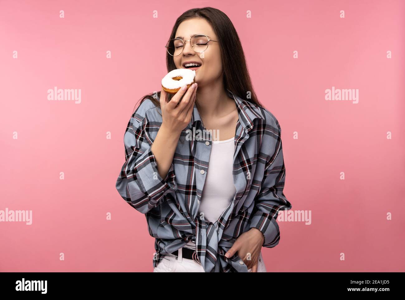 Photo of attractive lady holds eats donut sweet food, wear casual ...