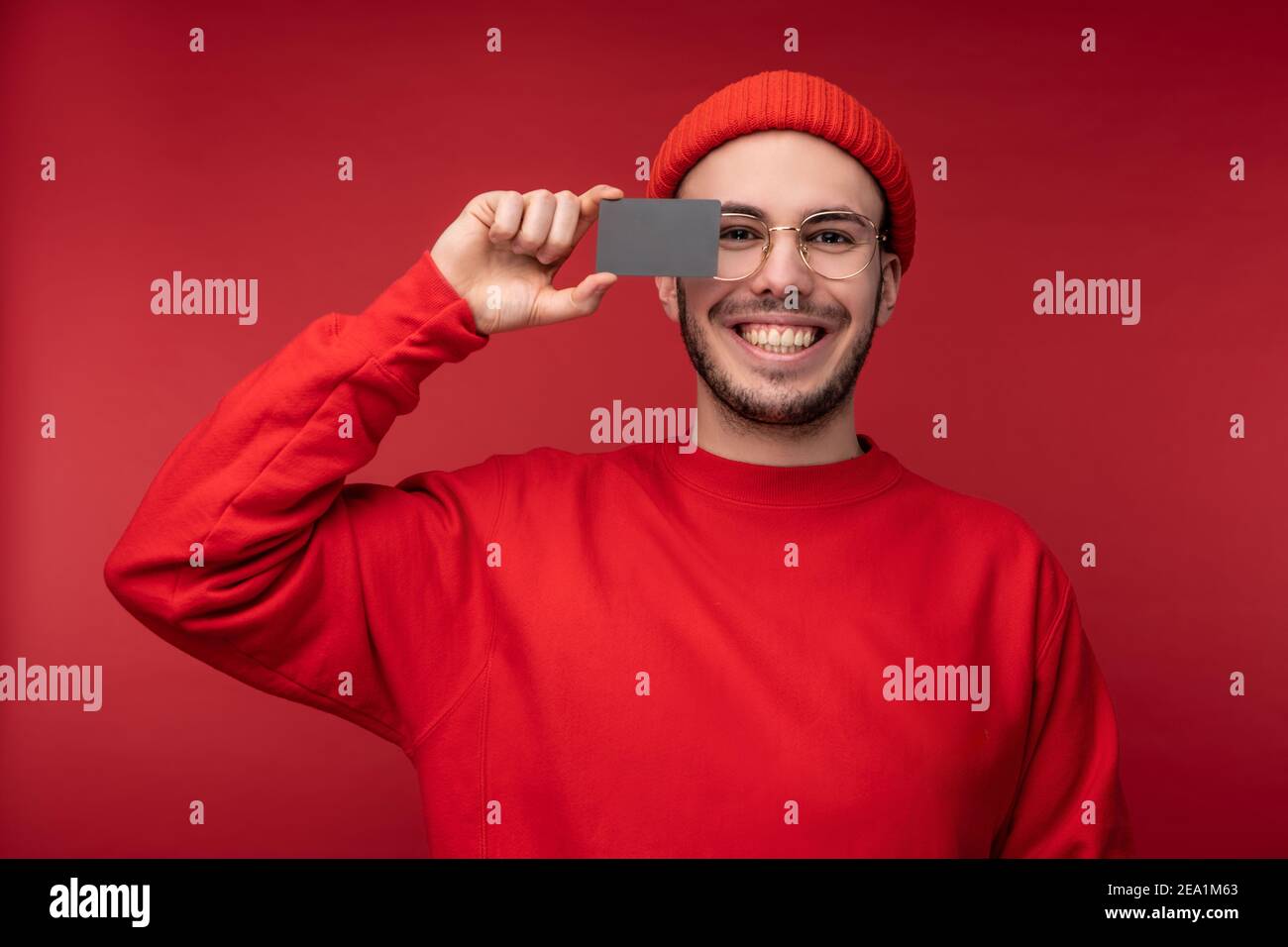 Photo of attractive man with beard in glasses and red clothing. Happy ...