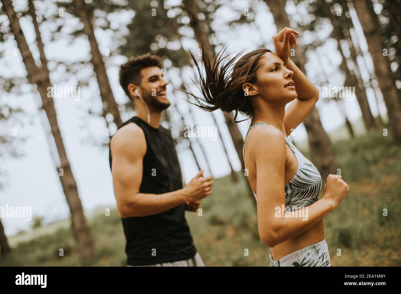 Young fitness couple running forest hi-res stock photography and images ...
