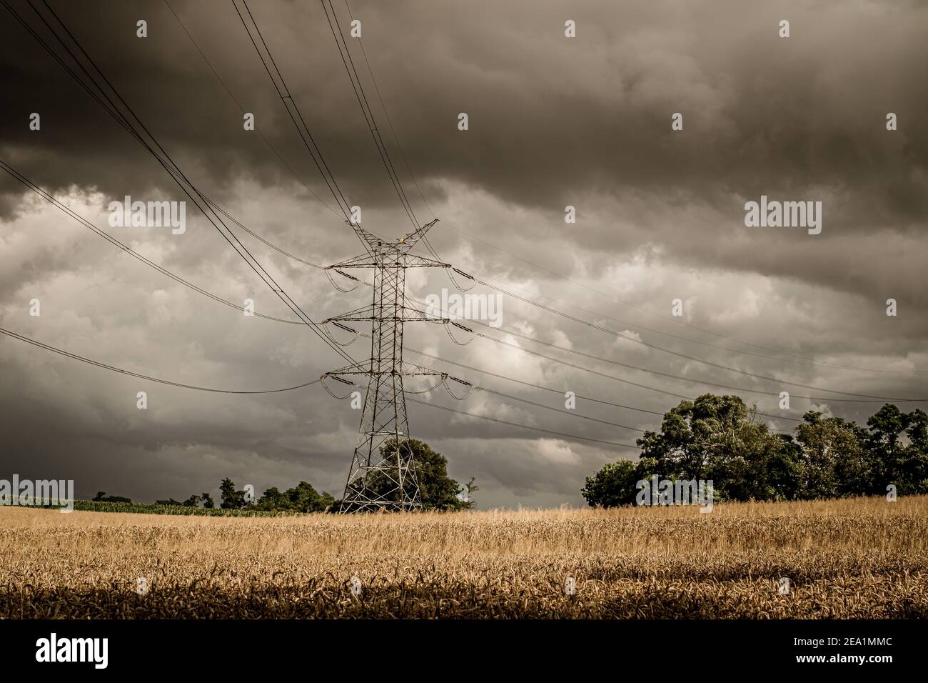A landscape with a transmission tower under a cloudy sky Stock Photo ...
