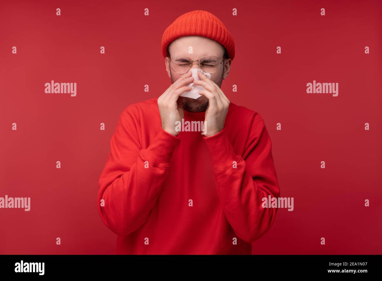 Photo of happy man with beard in red clothing sneezing get sick illness ...
