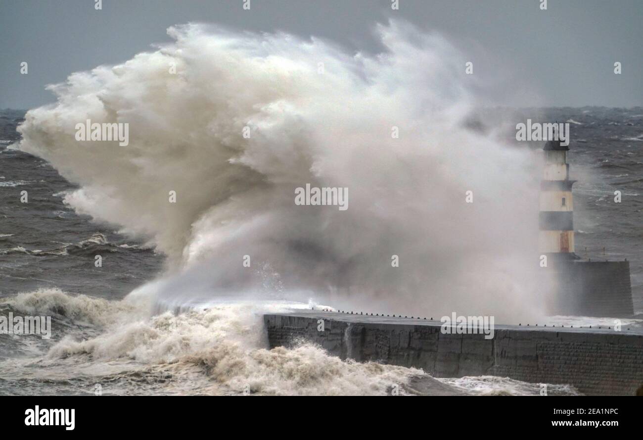 Huge waves crash over Seaham lighthouse in Durham as Storm Darcy sends ...