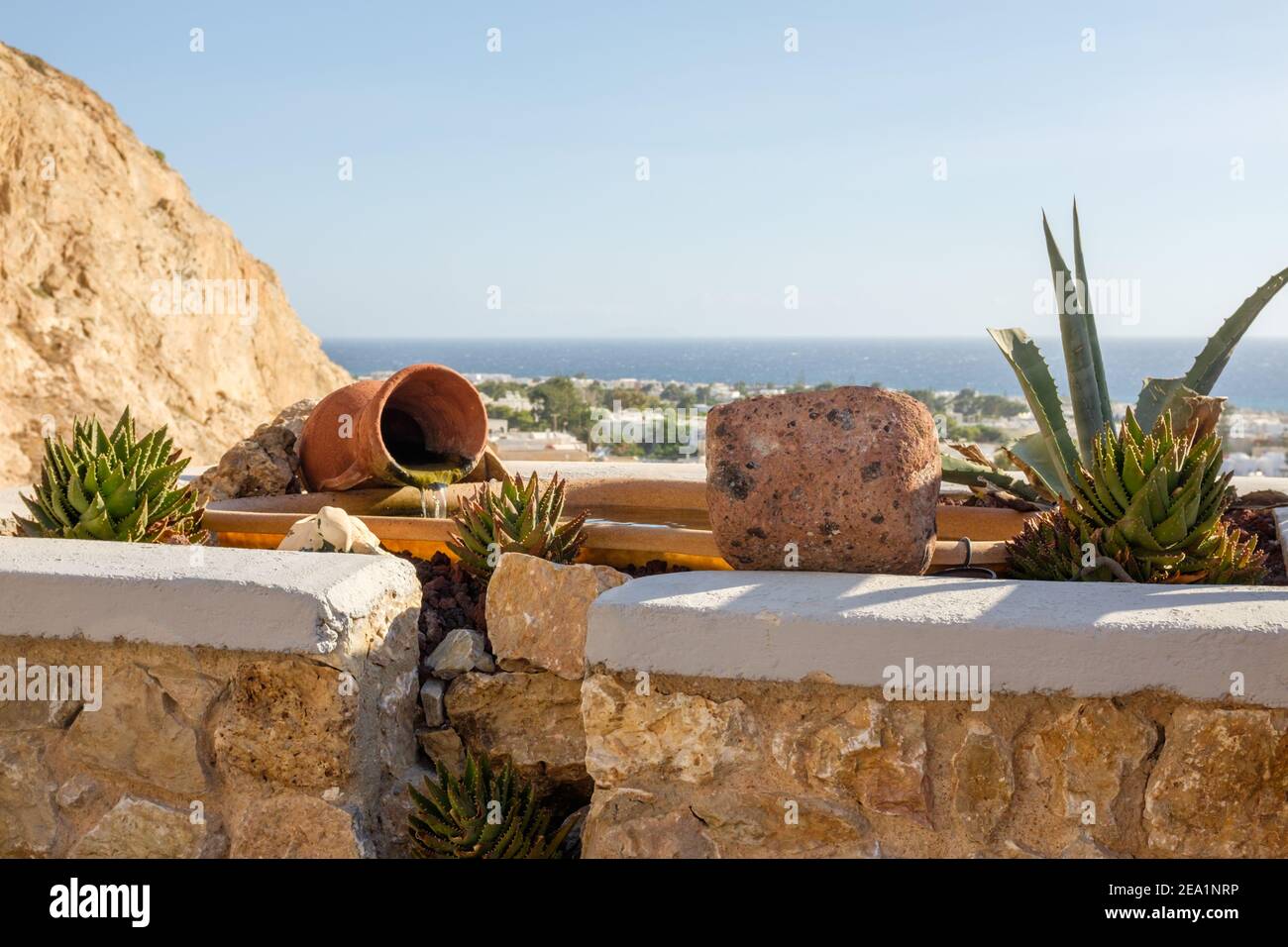 Water feature overlooking the Aegean Sea on the island of Santorini ...