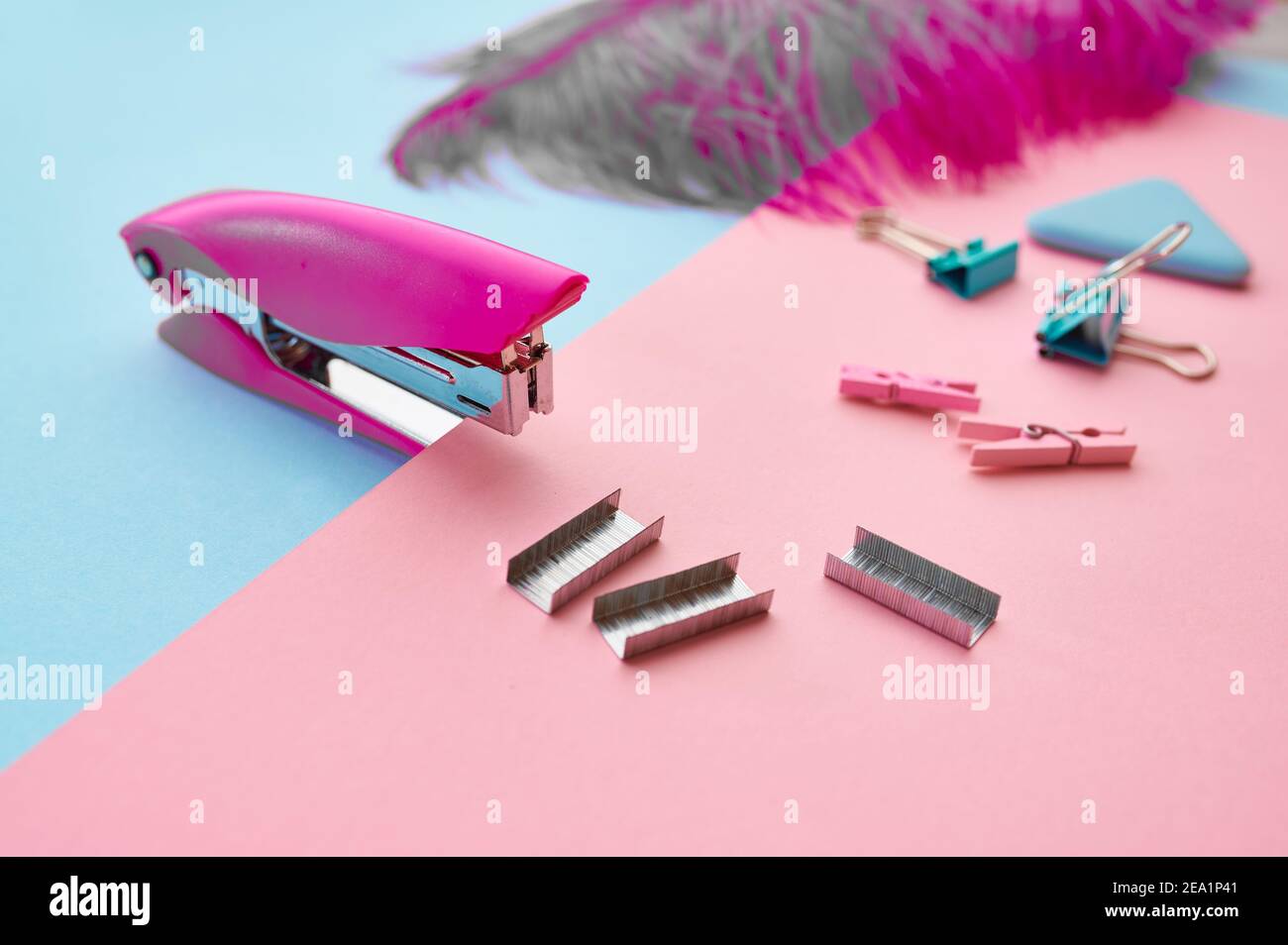 Stapler and clips closeup, blue background Stock Photo - Alamy