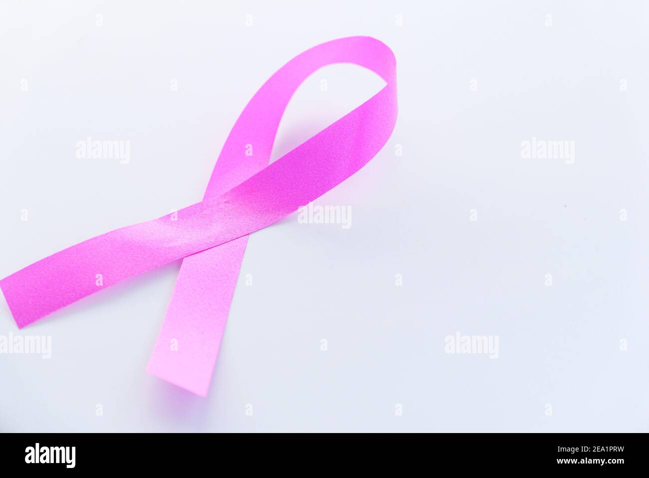pink color ribbon on white background close up Stock Photo - Alamy