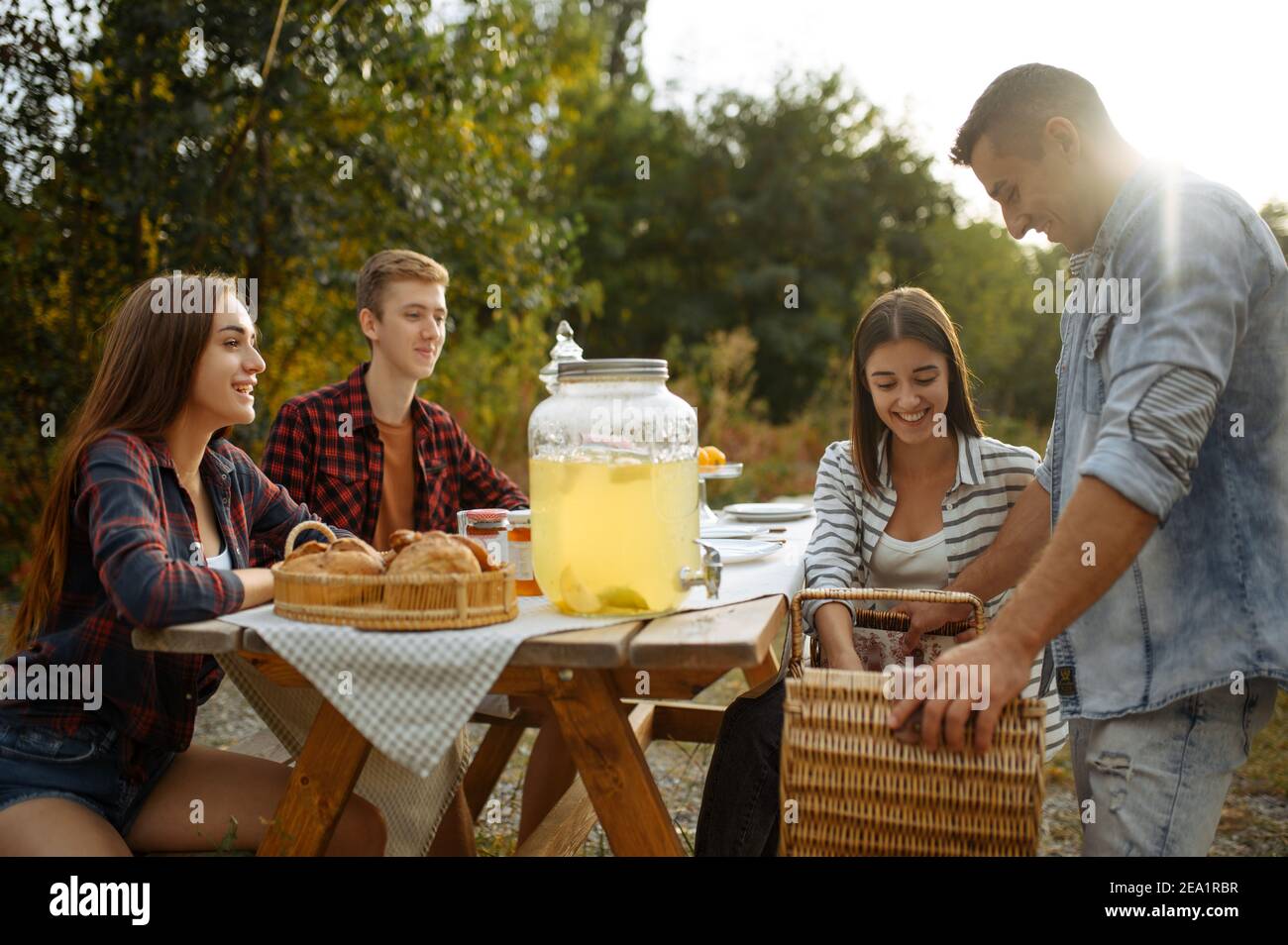 Young man sitting picnic table hi-res stock photography and images - Alamy